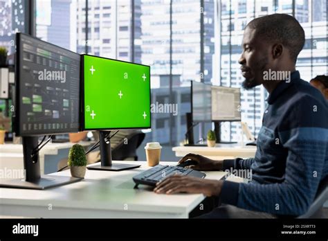 Developer Conducting Experiments And Tests On Green Screen Computer To