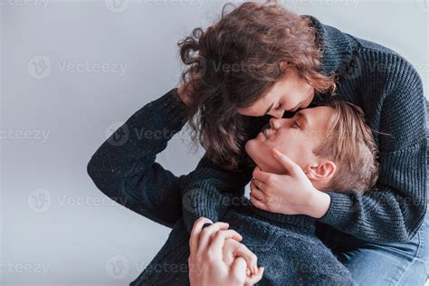 Cute Young Couple Kissing Each Other Indoors In The Studio 15250717