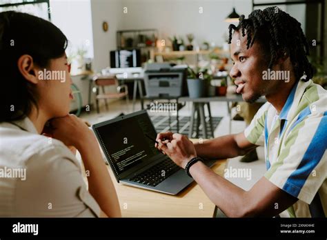 Gen Z African American Male And Asian Female Programmers Working On