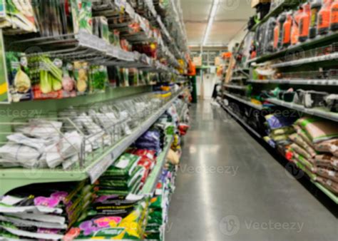 A Blurry Image Of A Hardware Store With Paints Varnish Brushes In A
