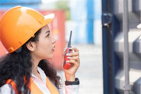 Portrait Of Female Worker In Cargo Containers In Shipping Container Yard Woman Holding Walkie