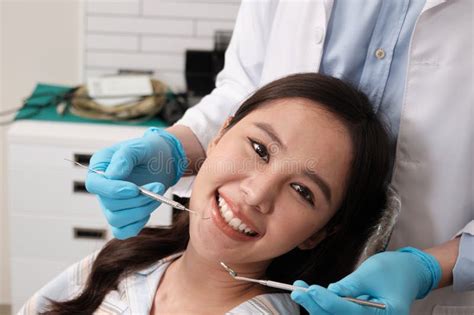 Asian Female Face White Teeth And Cheerful Face In The Dentist Clinic