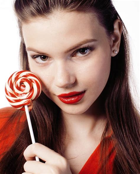 Young Pretty Brunette Girl With Red Candy Posing On White Background
