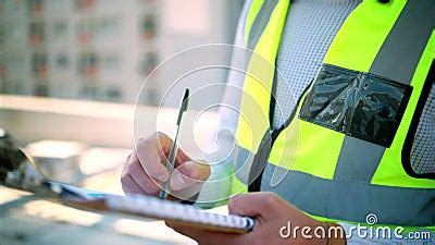 Checklist Writing And Clipboard With Safety Man On Construction Site Checking Or Signing