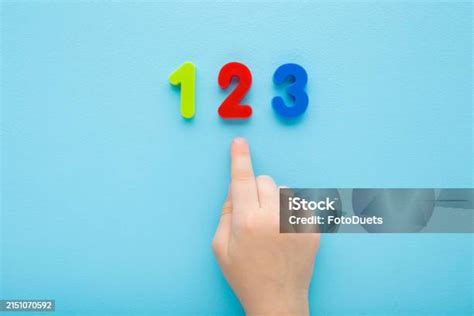 아기 소년 손 손가락 하늘색 테이블 배경에 화려한 123 숫자를 가리키고 있습니다 파스텔 색상 배움의 시간 근접 촬영 하향식 보기 1에 대한 스톡 사진 및 기타 이미지