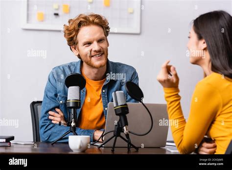 Redhead Broadcaster Looking At Brunette Woman During Interview In Radio Studio Stock Photo Alamy