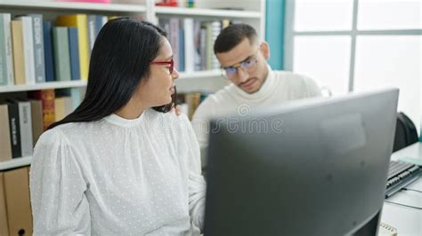 Man And Woman Students Using Computer Studying At University Classroom