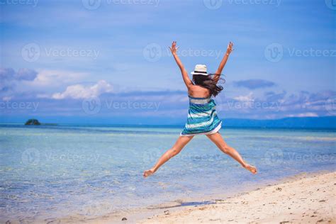 Young Woman Jumping And Raising Arms Up On The Beach 17754231 Stock