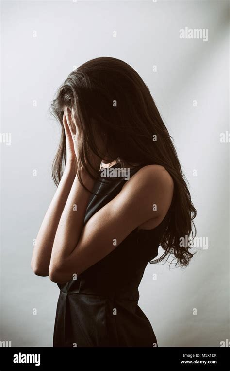 Side View Of A Sad Young Woman Hiding Face With Hands Crying Stock