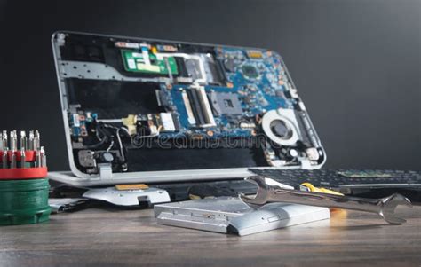 Broken Laptop With A Wrench And Screwdriver On The Table Computer Repair Service Stock Photo