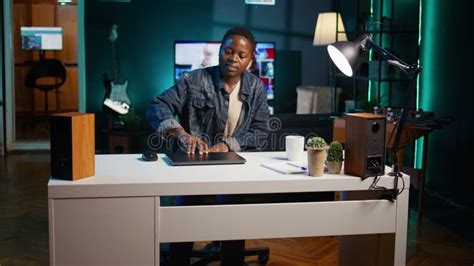 Freelancer In Neon Lit Home Office Sitting At Desk And Typing On Laptop Stock Footage Video Of