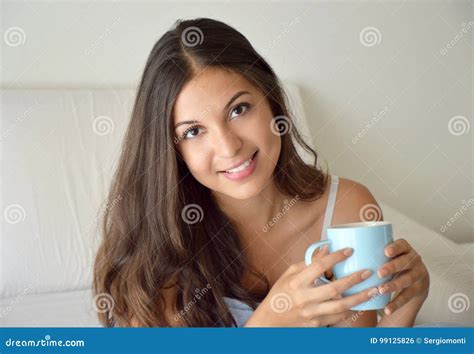 Portrait Pretty Girl Drinking Coffee Or Tea On Bed In The Morning In