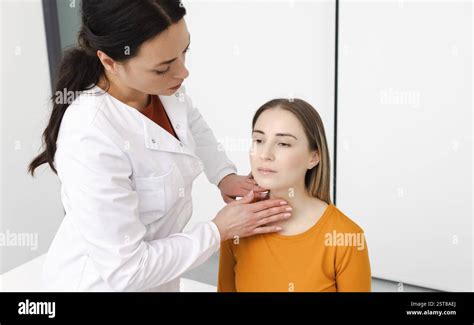 Thyroid Gland Exam And Treatment Doctor Palpates Of Womans Neck For