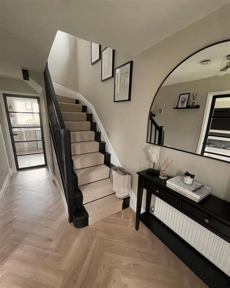 Elegant Neutral Entryway With Black Accents Herringbone Flooring And