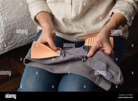 Woman Inserting Ribbed Foam Pads Into Compression Garment Pocket For