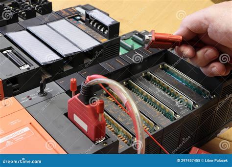 A Hand Holds A Communication Cable To The PLC Focused On The Connector Stock Image Image Of