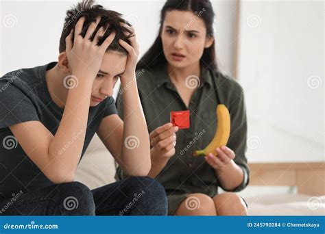 Mother Talking With Her Teenage Son About Contraception At Home Sex Education Concept Stock
