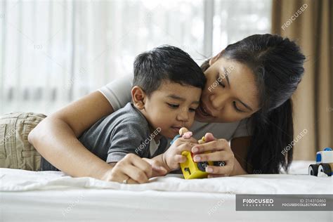 Asian Mother And Son Playing With Toys On The Bed Kid Smile Stock Photo 214310460