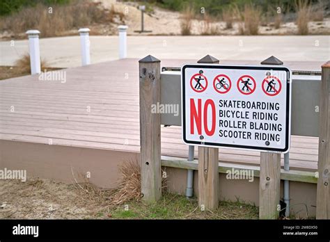 A Sign Informs The Public Of No Skateboarding Bicycle Riding Roller