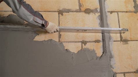 View Of Builder Hands Plastering On Block Wall Worker Leveling The