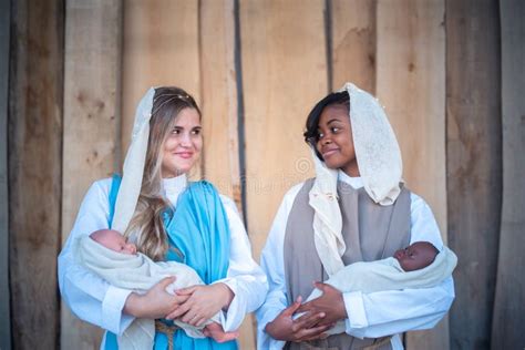 Lesbian Caucasian And Afro Woman Representing Virgin Mary Stock Photo Image Of Baby Crown