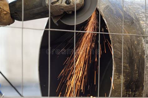 Shallow Depth Of Field Selective Focus Details With A Worker Using An Angle Grinder On An