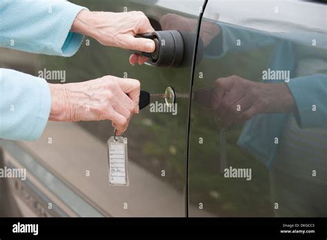 Woman Using Key To Unlock Car Door Stock Photo Alamy