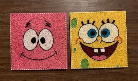 Two Spongebob Coasters Sitting On Top Of A Wooden Table