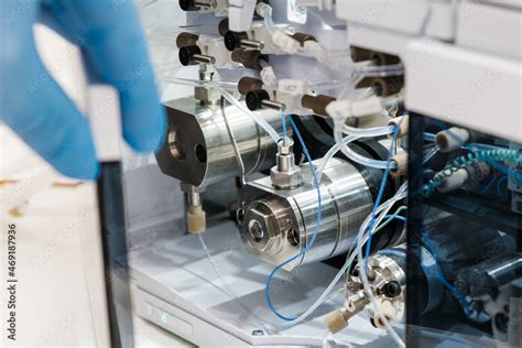 Scientist Hand Opens The Door With Binary Pump For Mixing For Hplc