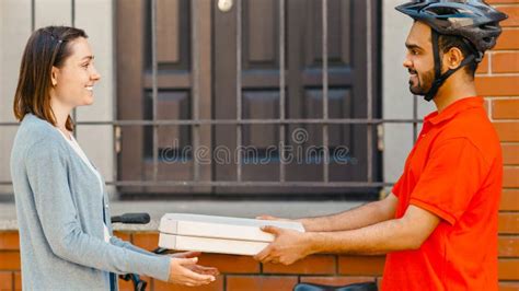 Pizza Delivery Service Smiling Courier In Helmet With Bicycle Gives