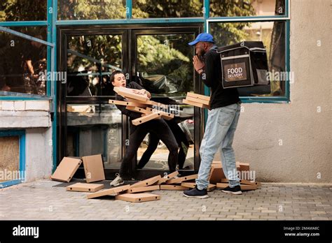 confused office food delivery customer catching falling pizza boxes