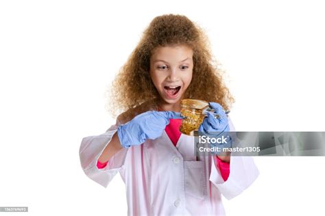 흰색 스튜디오 배경에 고립 된 흰색 실험실 코트와 장갑을 입은 치과 의사의 이미지에서 귀여운 아름다운 어린 소녀의 반 길이 초상화 8 9 살에 대한 스톡 사진 및 기타