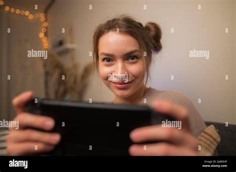 Close Up Girl Gamer Plays A Video Game On A Portable Game Console