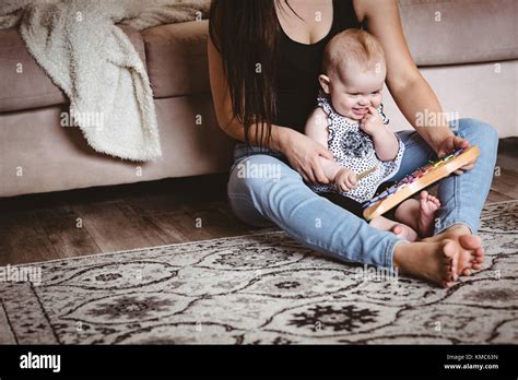 Mother And Baby Playing With Wooden Toy Stock Photo Alamy