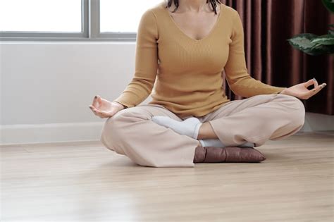 Premium Photo | Cropped image of woman meditating to release stress ...