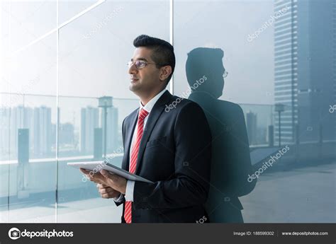 Indian Businessman Analyzing Financial Report Tablet Indoors Office