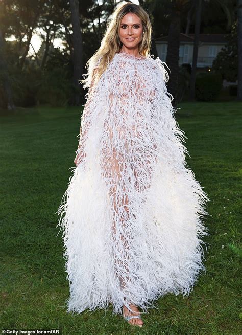Heidi Klum Barely Protects Her Modesty In A Semi Sheer White Feathered Gown As Braless