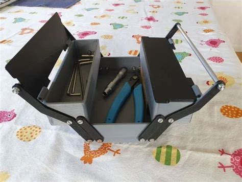 A Pair Of Scissors Are In A Box On A Bed