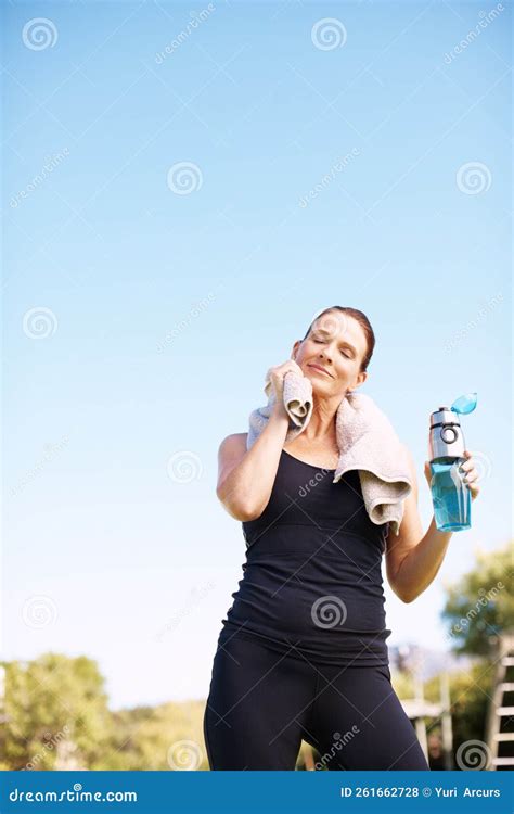 My Body Feels Happy After This Workout A Woman Standing And Rubbing Her Face With A Towel After