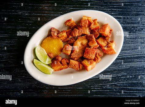 Colombian Fried Pork Belly Chicharrón Colombiano With Sliced Limes