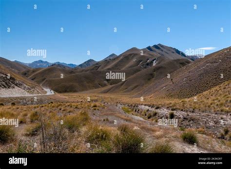 Lindis Pass A Mountainous Road Highway 8 Across A Barren Landscape