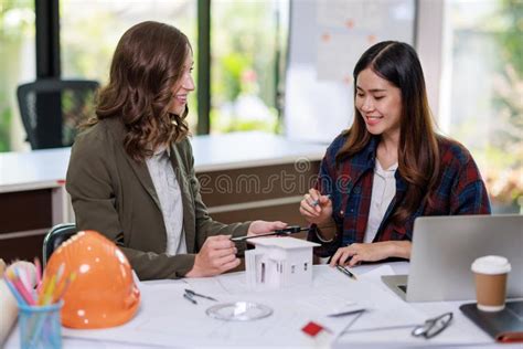 Construction Concept Of Engineer And Architect Working With Construction Model And Blueprint