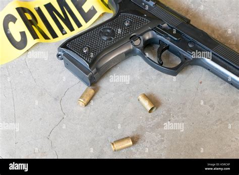 Crime Scene Concept With Gun Crime Scene Tape And Bullet Casings Stock