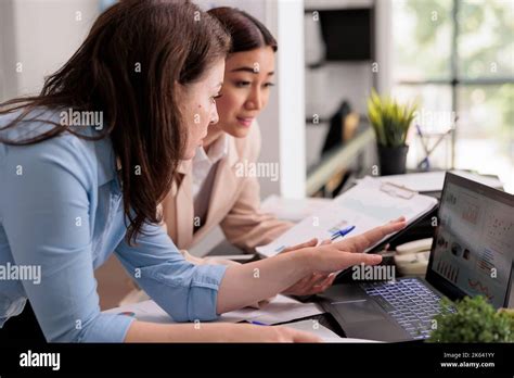 Start Up Company Employees Analyzing Financial Report Statistics Comparing Data On Documents