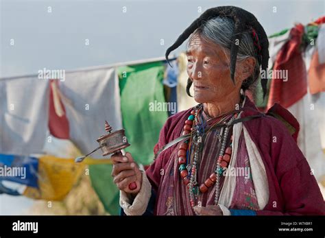 Old Lady In Traditional Mompa Tribe Dress Typical Head Dress Made From
