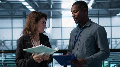 Data Center Management Executives Reading Paperwork Files Reviewing