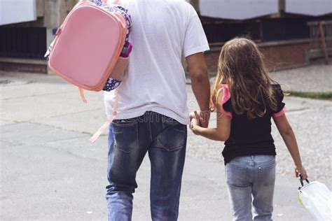 Father Taking His Daughter To School With Copy Space Stock Image