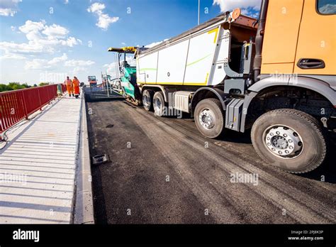 Project Is In Progress Dumper Truck Is Reloading Hot Asphalt Into