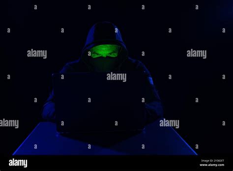 Cyber Hacker Digital Cybersecurity Concept With Hooded Hacker And Computer Interface On Dark