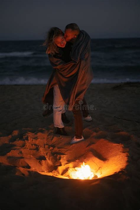 Night Romantic At The Sea Beach Couple Hugging Together Near Campfire